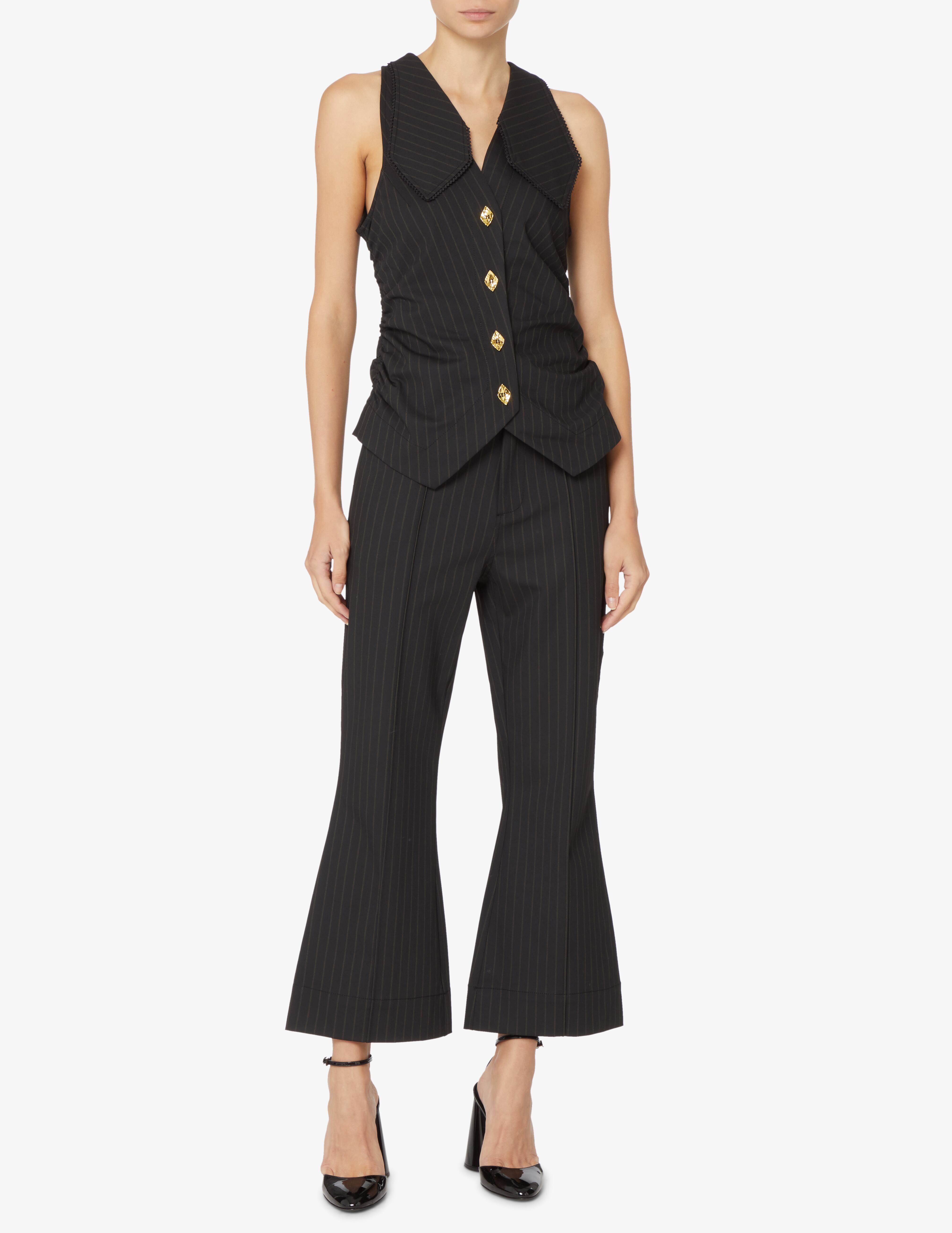 Shop Ganni High rise trumpet pants - Black on Rinascente
